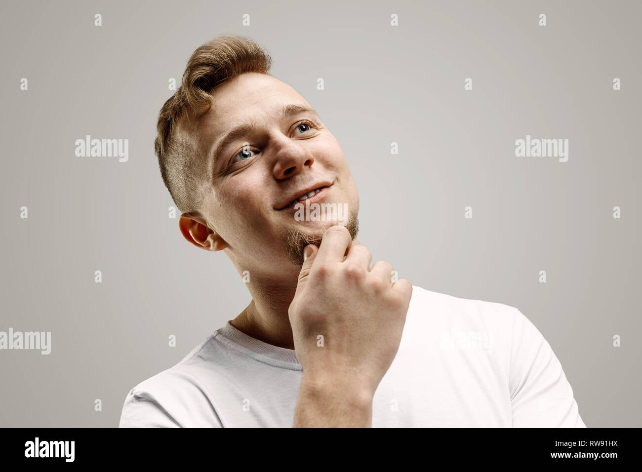 Happy business man standing, smiling isolated on gray studio background ...