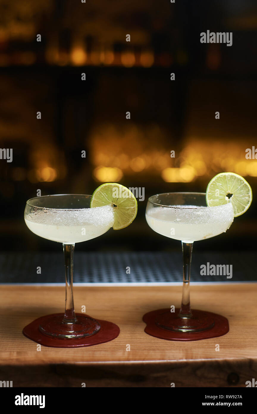 two margarita cocktails with tequila and Cointreau at wooden bar ...