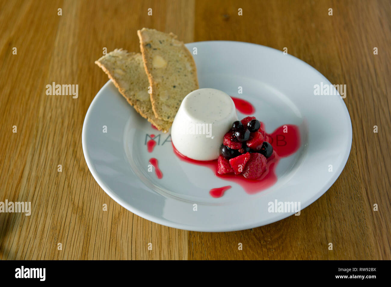 Vanilla panna cotta with a fruit compote Stock Photo - Alamy