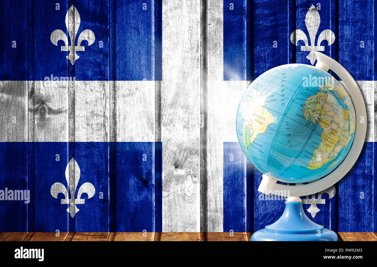 Globe with a world map on a wooden background with the image of the ...