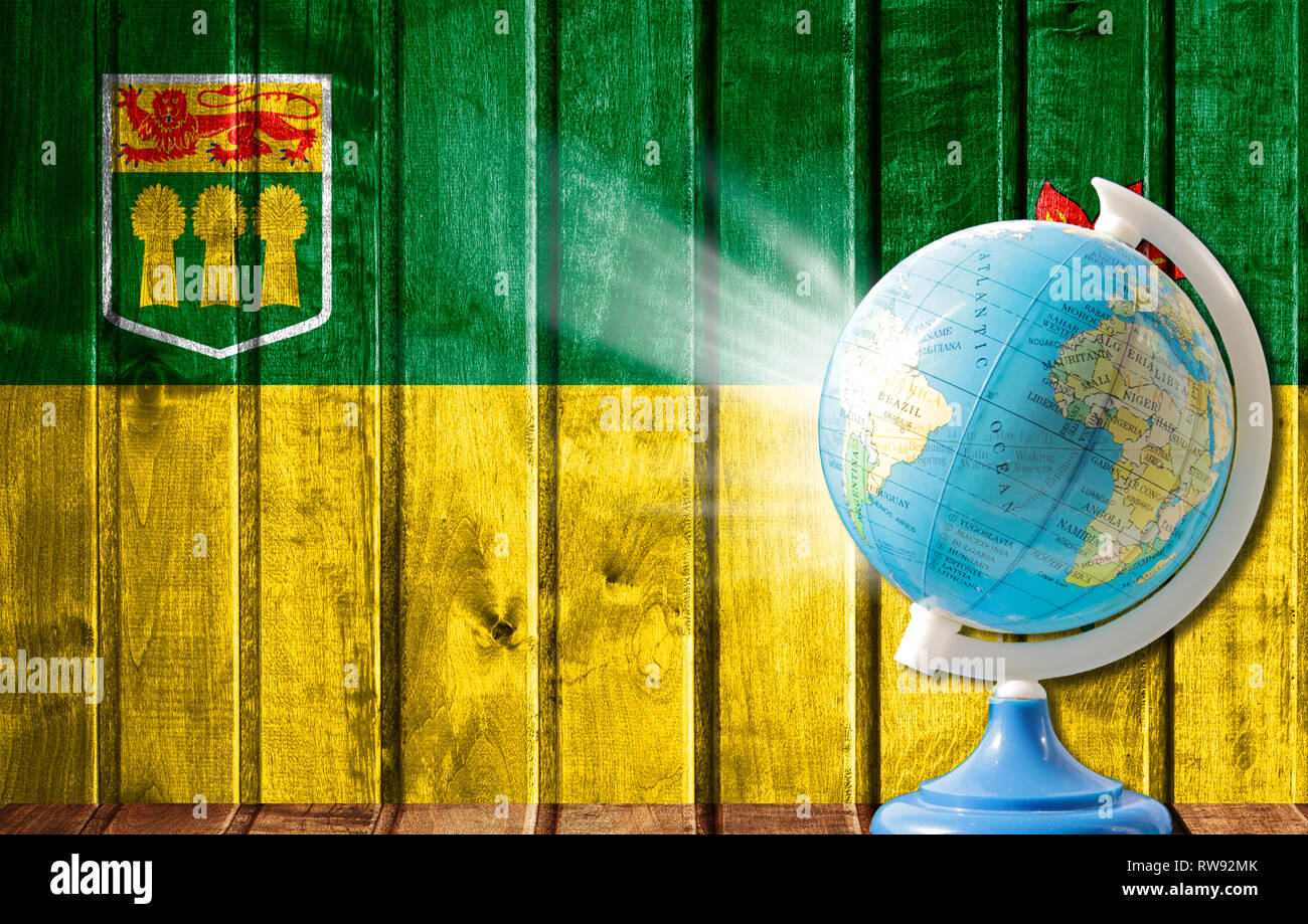 Globe with a world map on a wooden background with the image of the ...