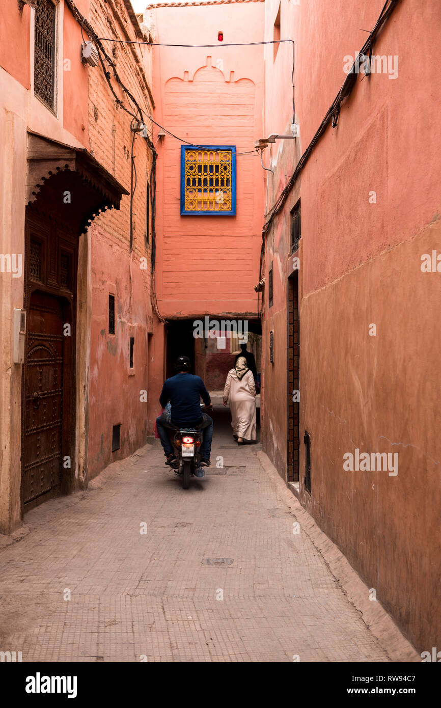 Typical Moroccan alley within the souks of the Medina of Marrakesh with ...