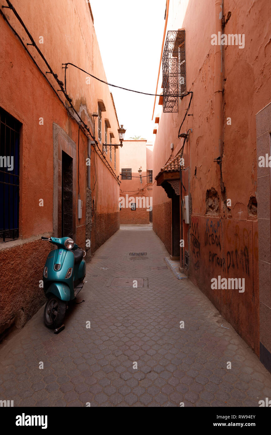 Typical Moroccan alley within the souks of the Medina of Marrakesh with ...