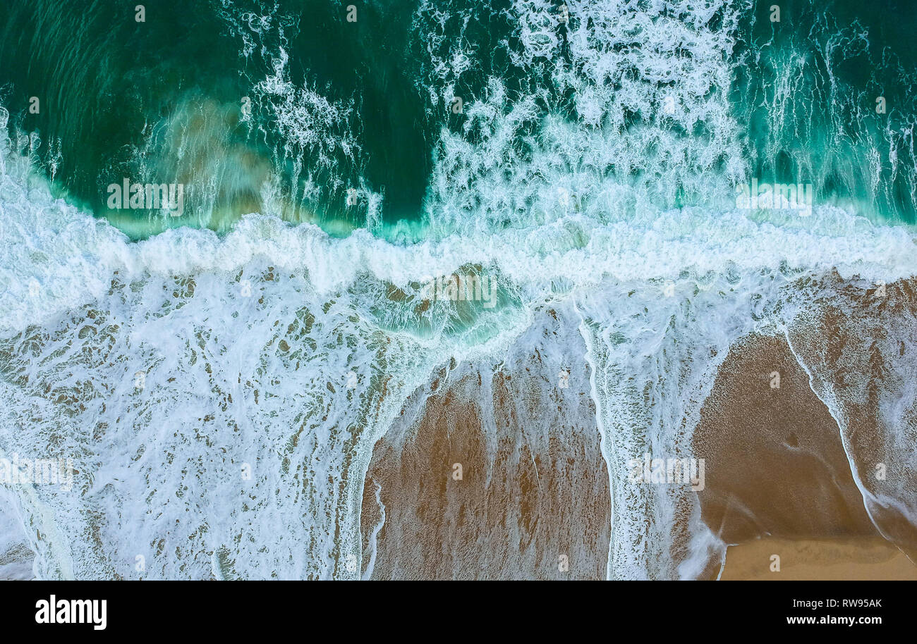 Aerial view of sandy beach with waves and clear ocean water. Drone ...