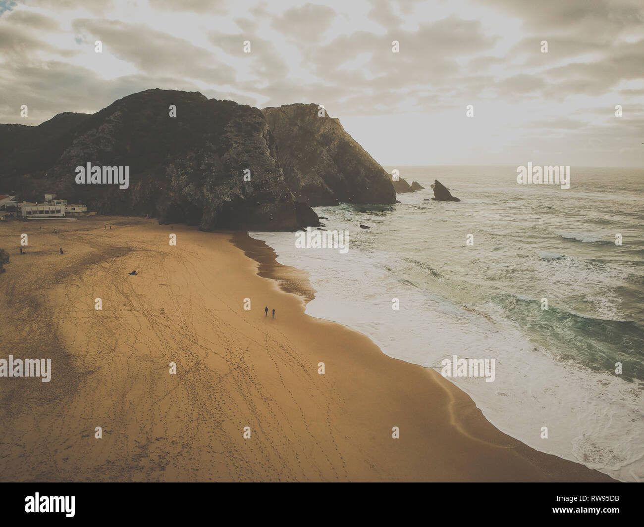 Aerial view from a sandy beach at the sunset with an amazing cliff ...