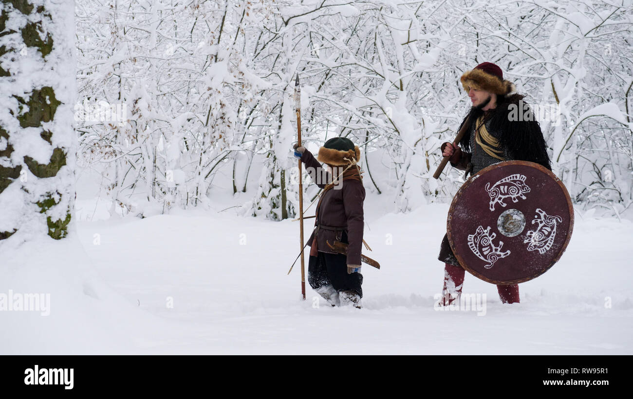 Father viking with his son going in the winter forest Stock Photo - Alamy