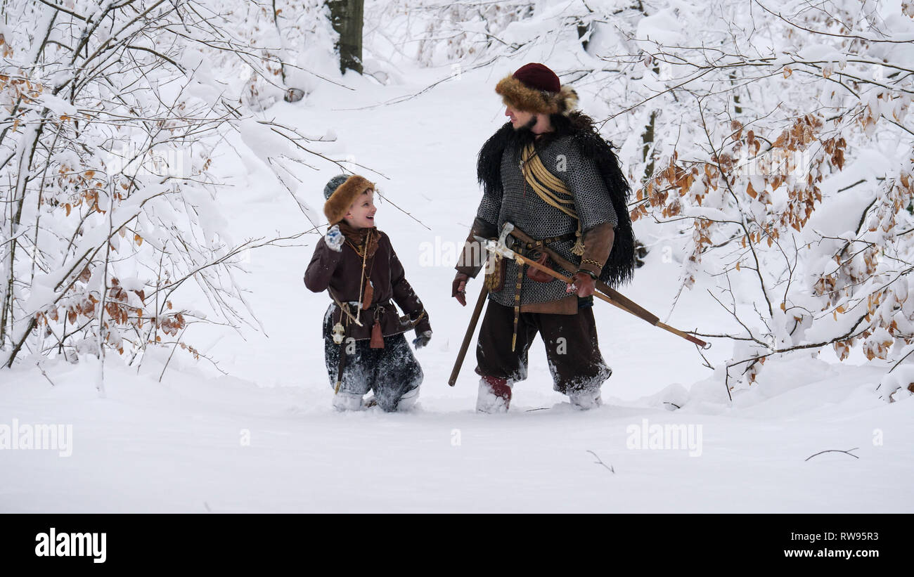 Father viking with his son going in the winter forest Stock Photo - Alamy