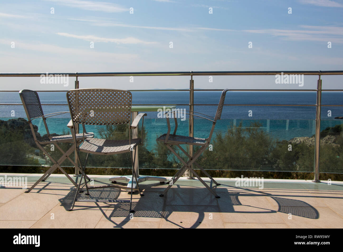chairs and table overlooking ocean Stock Photo - Alamy