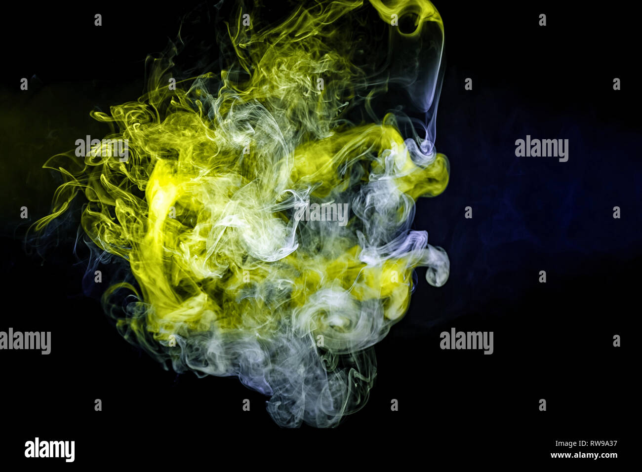 Thick colorful smoke of green, blue on a black isolated background ...