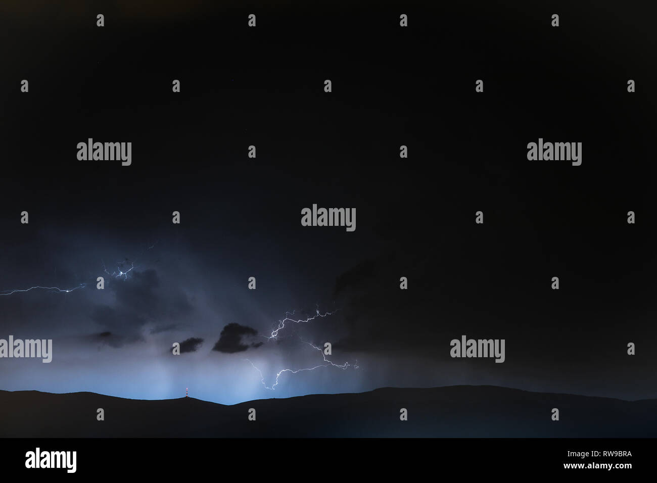 Storm raging in mountains with litghtning and thunder Stock Photo - Alamy
