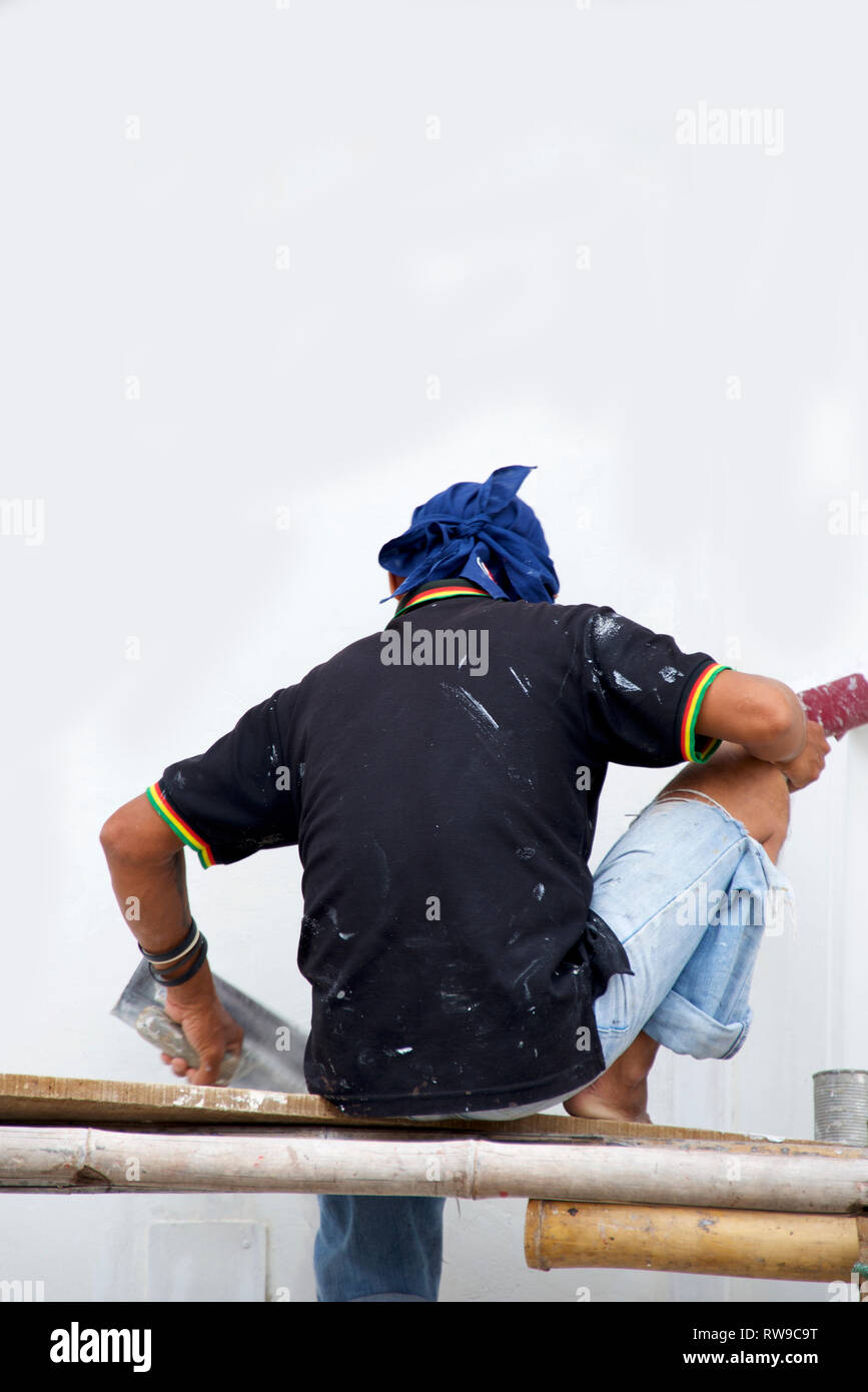 man hand with trowel plastering a wall skim coating plaster walls Stock ...