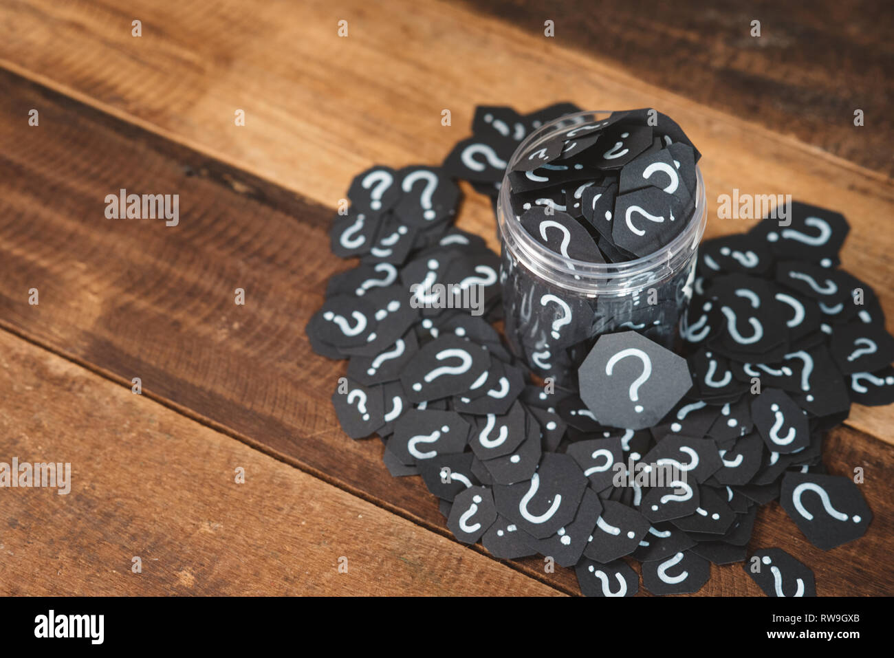 high angle view of a black paper cut with question mark in a plastic ...