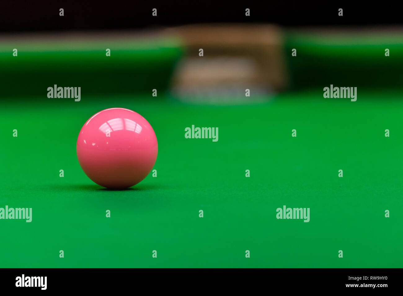 Pink snooker ball on green table background Stock Photo - Alamy