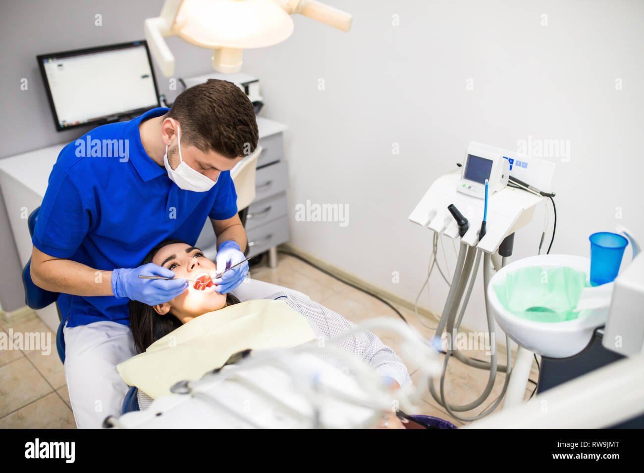 Dentist check-up teeth to young woman patient in clinic Stock Photo - Alamy