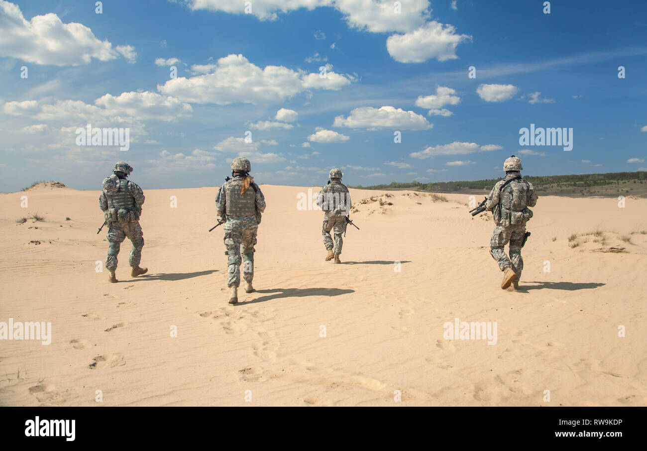 Team of United States airborne infantry men patrolling the desert Stock ...