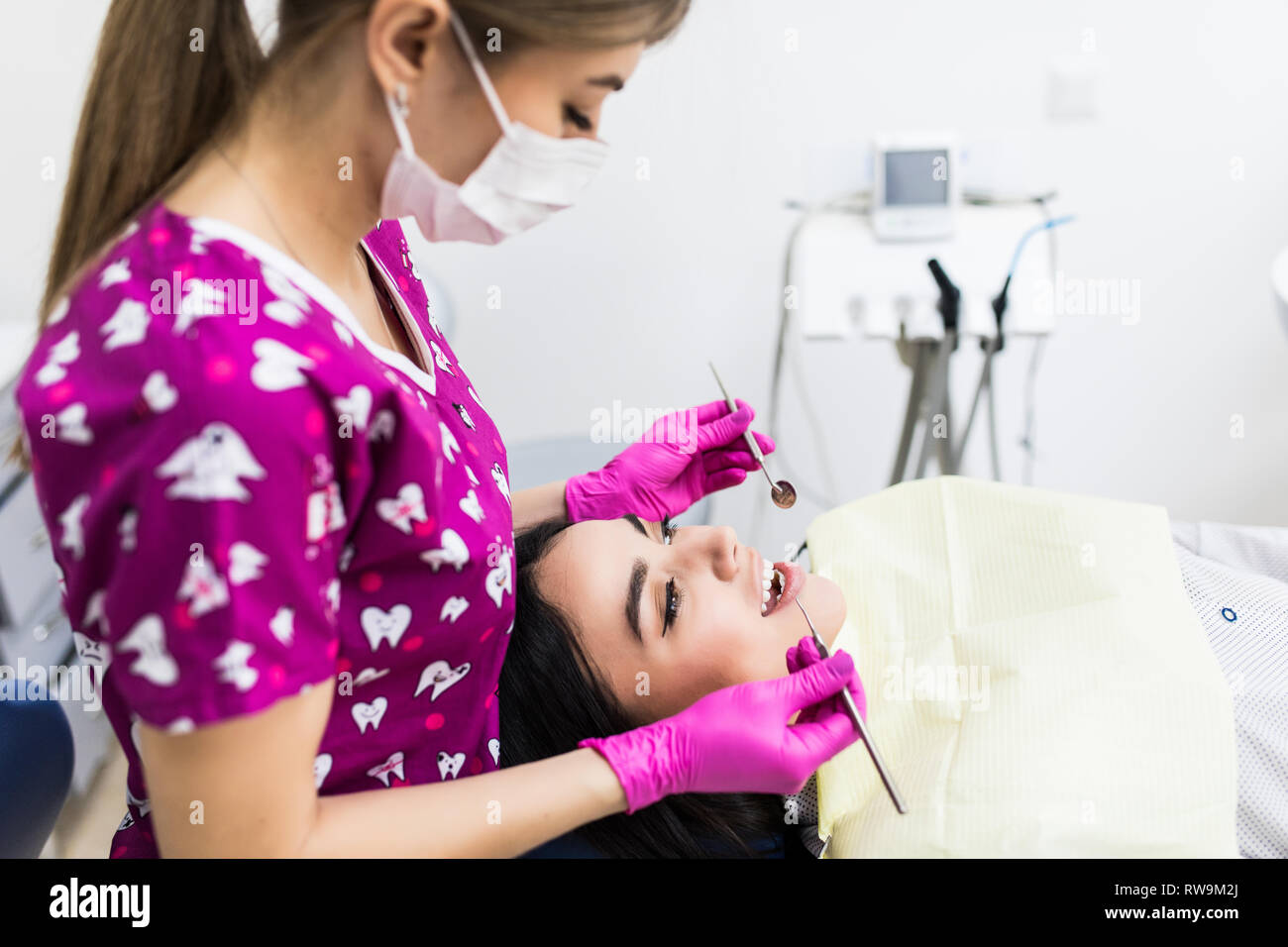 Young woman having dental check-up in dentist's office, smiling ...