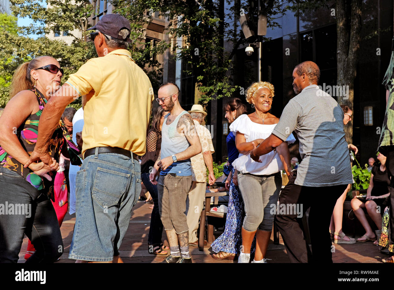 A diverse group of people dance outdoors in the Playhouse Square ...