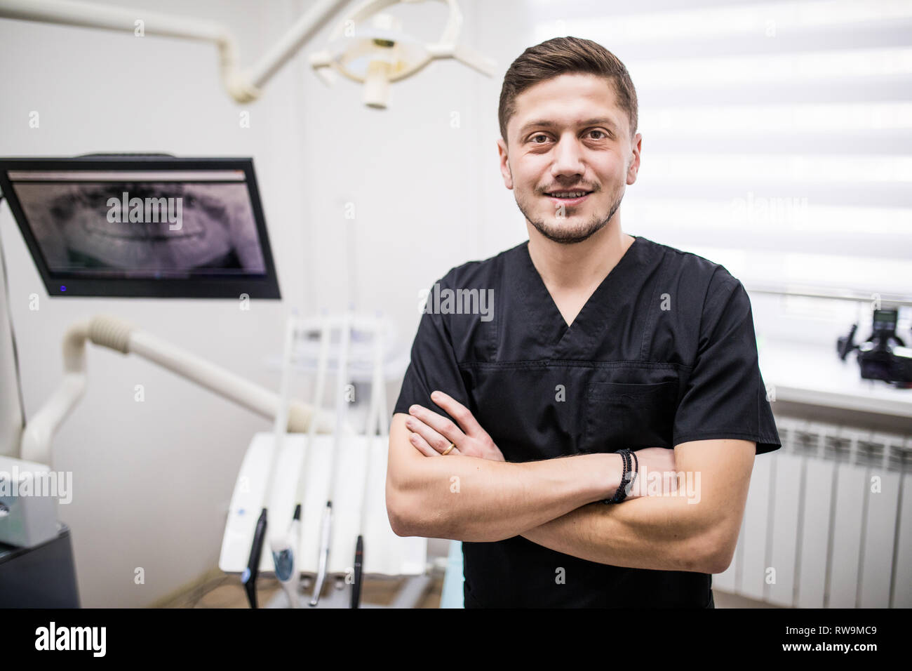 Dentist standing in examination room hi-res stock photography and ...