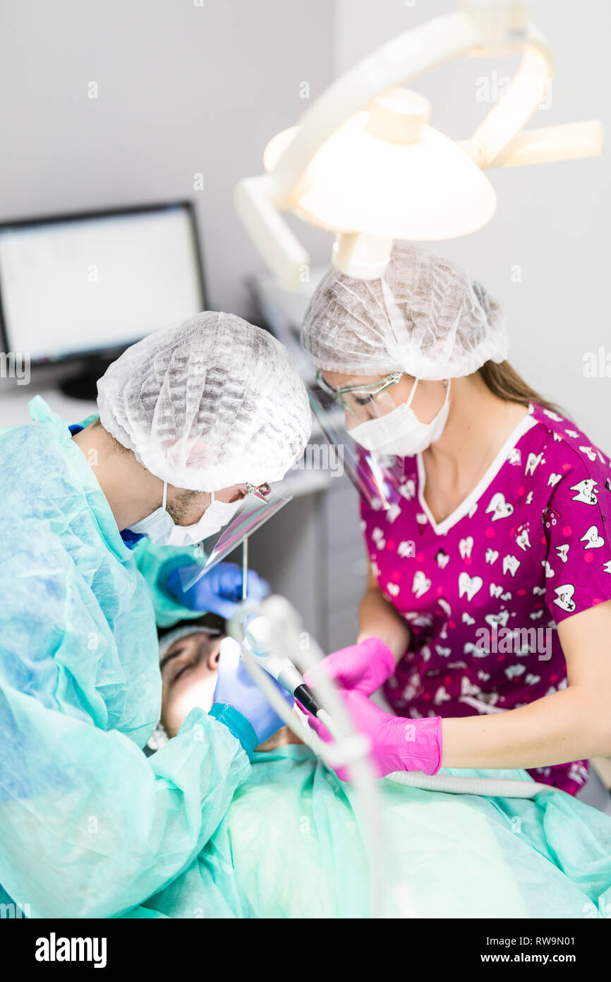 doctor operating man in cabinet with eyes closed during procedure made ...