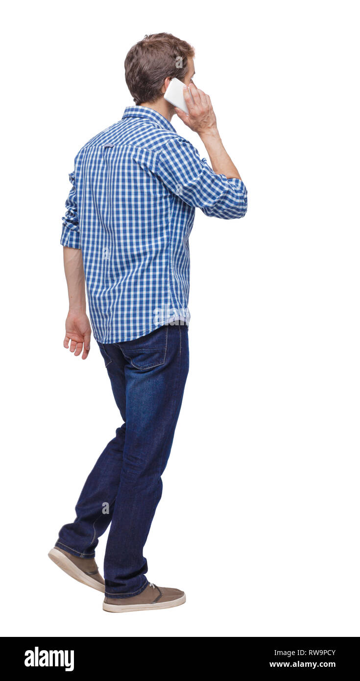side view of man walking with a mobile phone. backside view of person ...