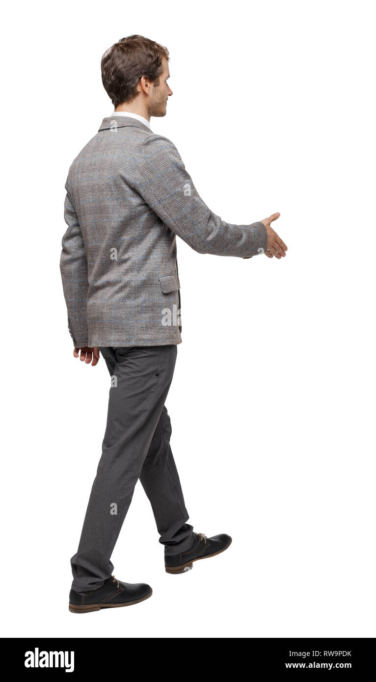 Back view of a walking businessman who stretches his hand for a ...