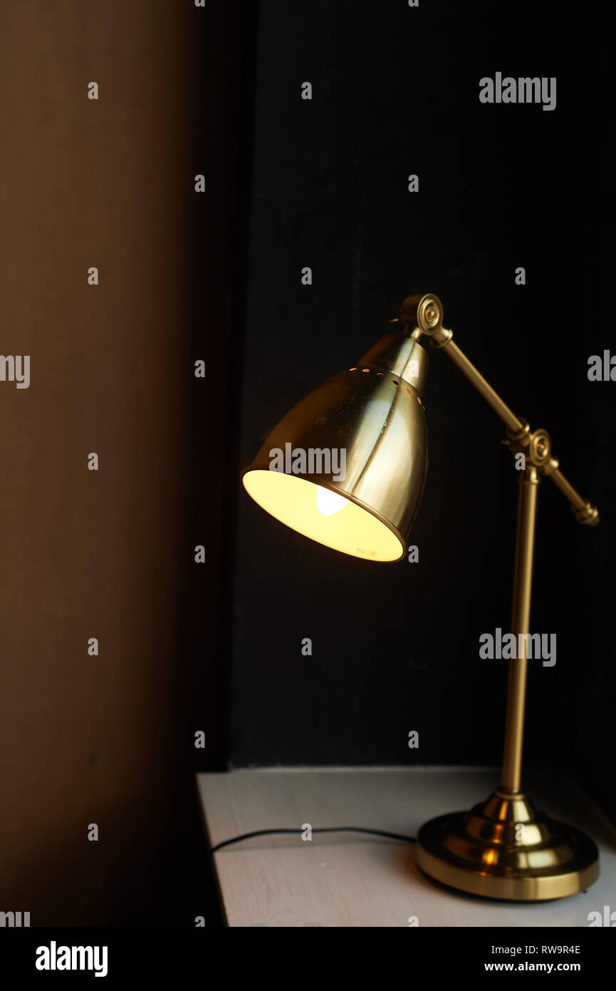 Metal table lamp of gold color.With warm temperature lamp Stock Photo ...