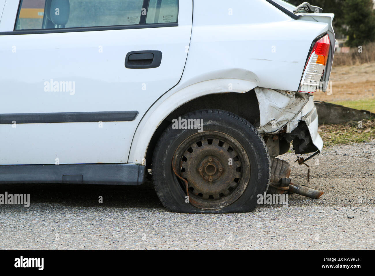 The car destroyed during the traffic accident stands by the road and is ...