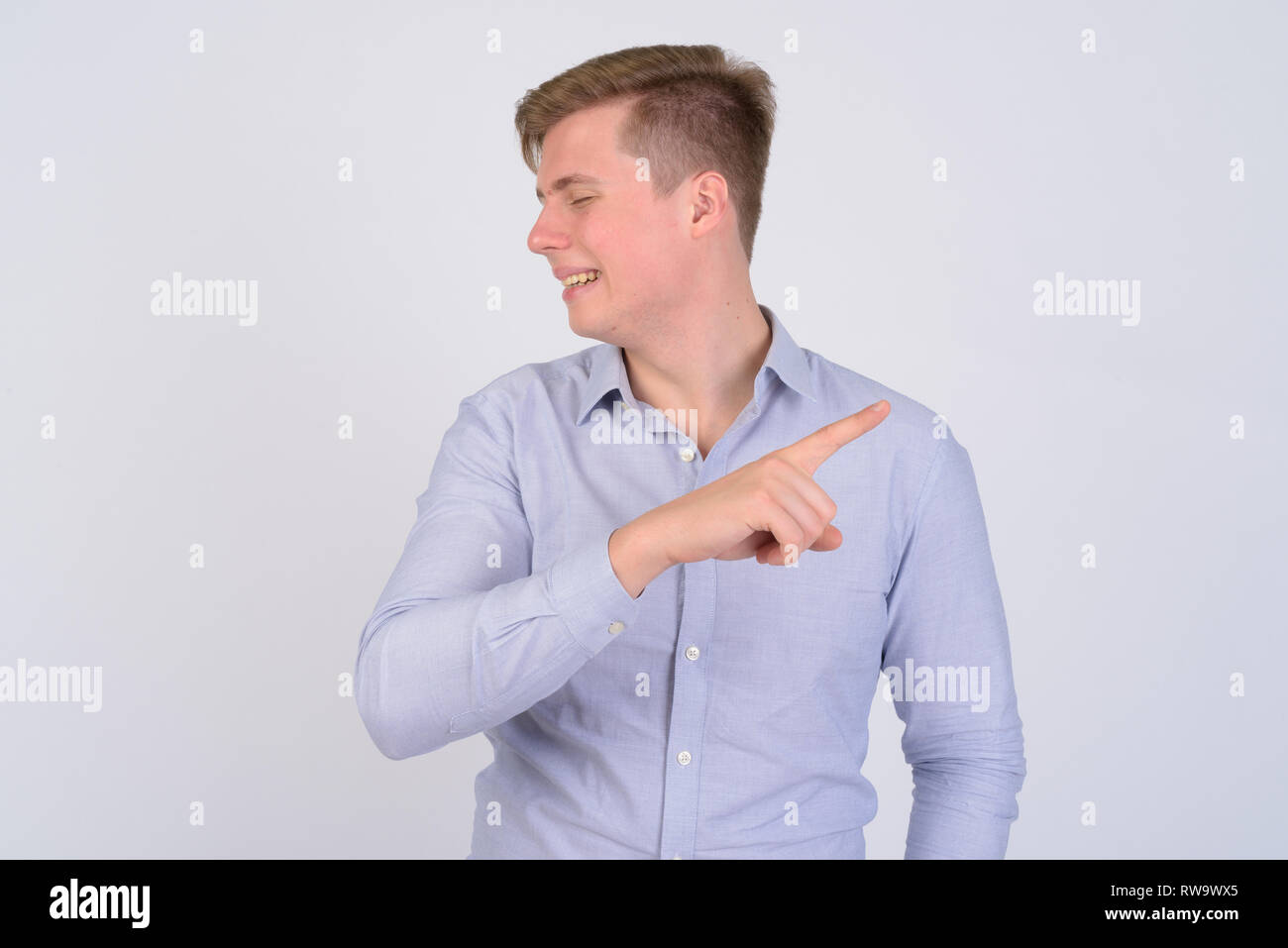 Young happy blonde businessman laughing while pointing finger Stock ...