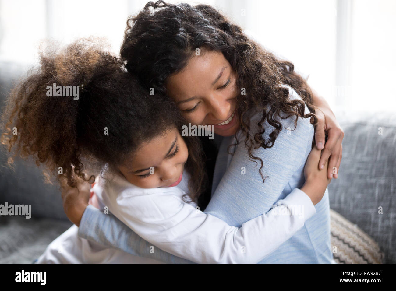 Happy African American mom and daughter hug making peace Stock Photo - Alamy