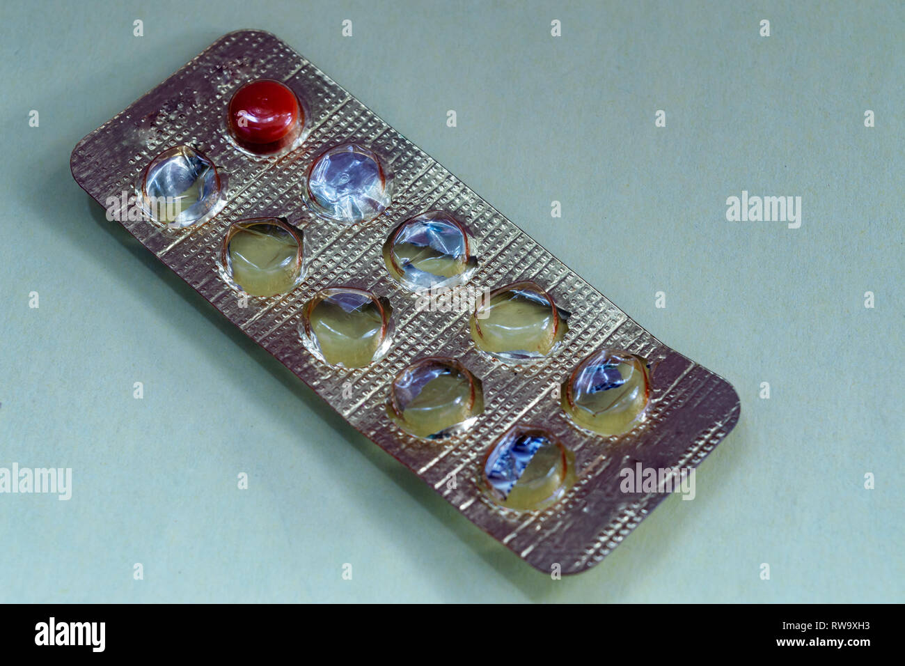 empty packaging of tablets, one tablet Brown, blue background Stock ...