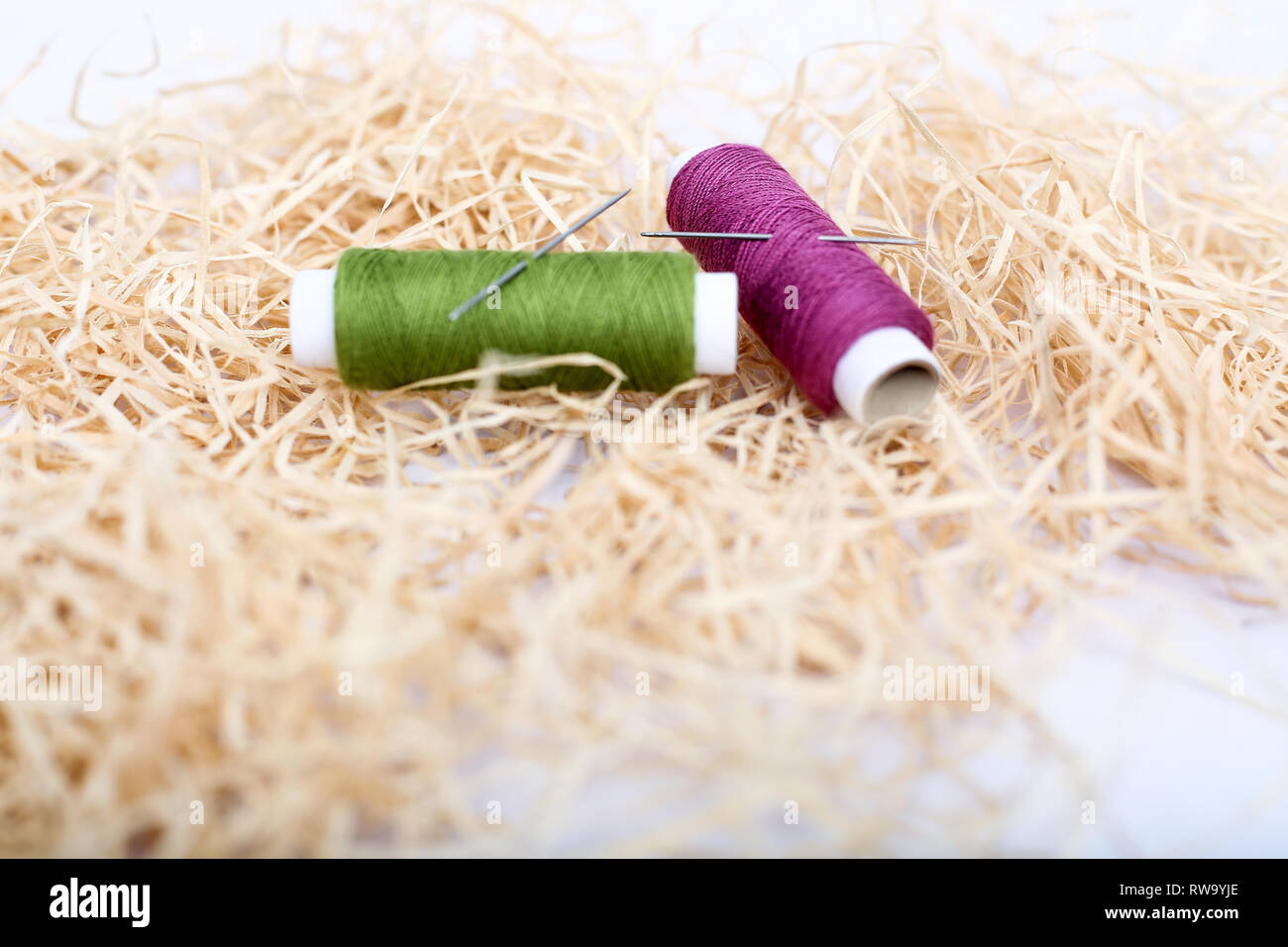 Spool of two sewing thread with needle. Isolated on the white ...