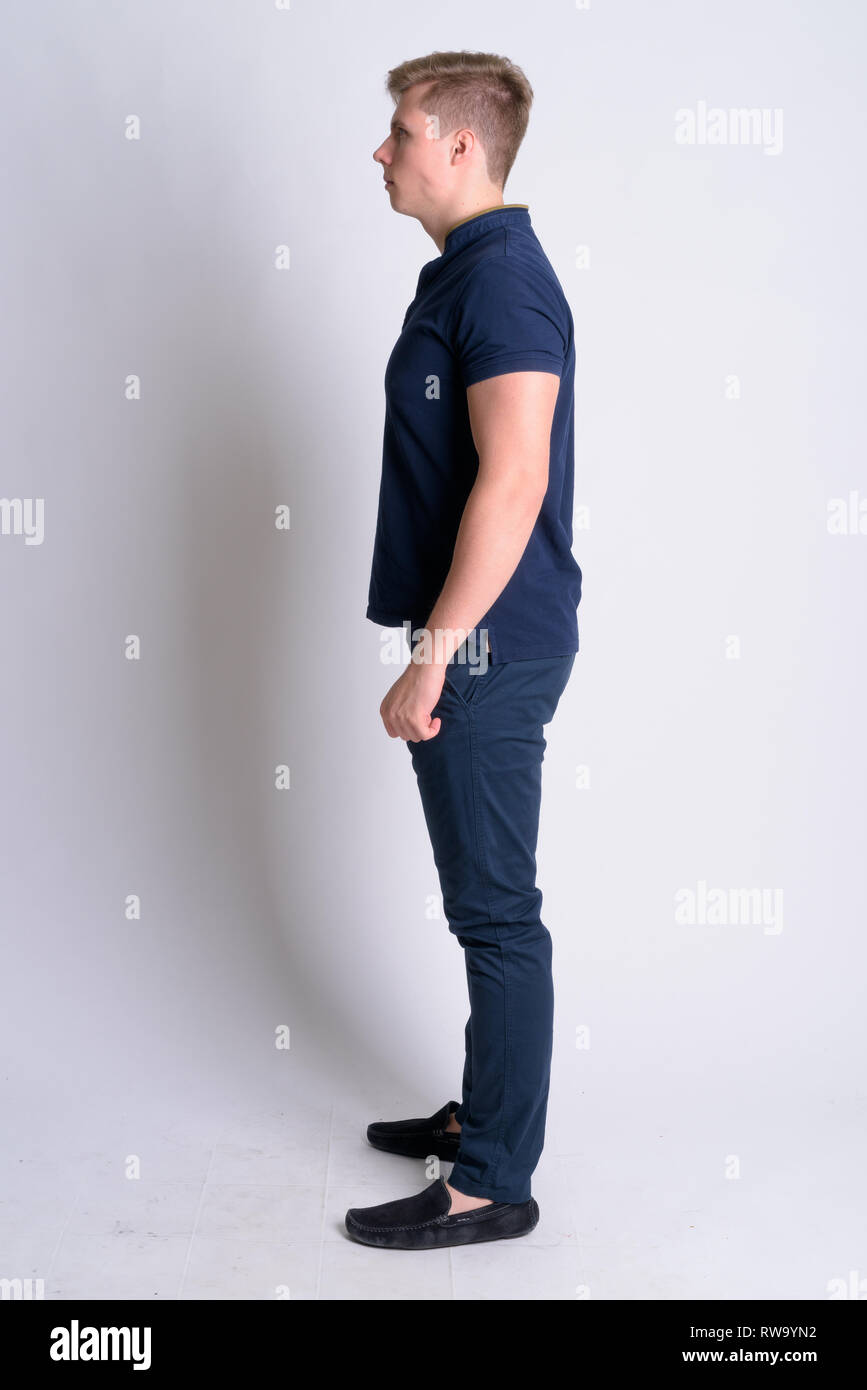 Full body shot profile view of young blonde handsome man Stock Photo ...