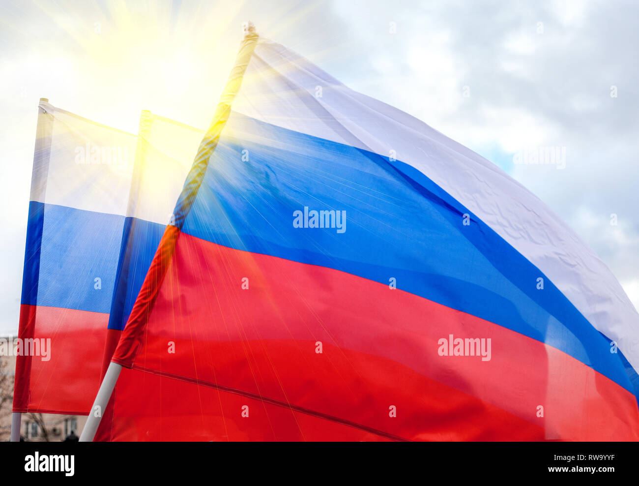 Russian national flags waving in the wind over sky and bright sun Stock ...