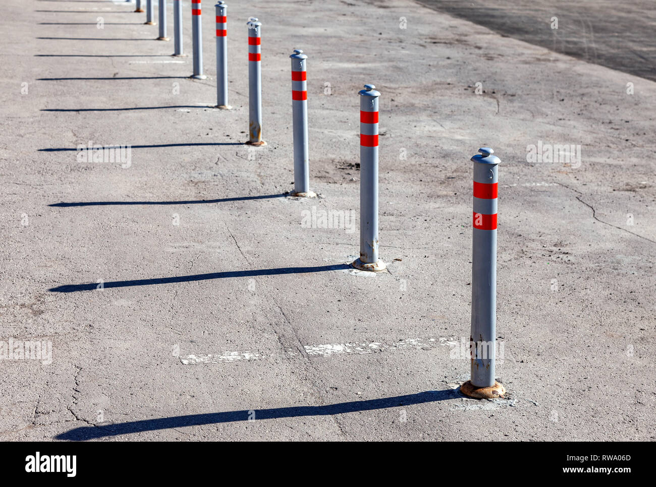 Gray warning bollards with red stripes at the parking zone Stock Photo ...