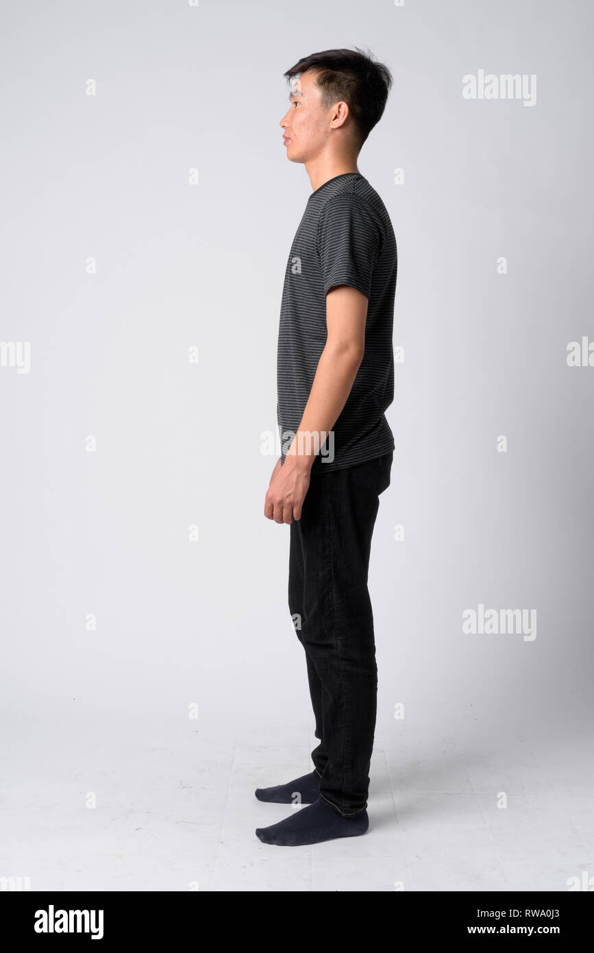 Full body shot profile view of young handsome Asian man Stock Photo - Alamy
