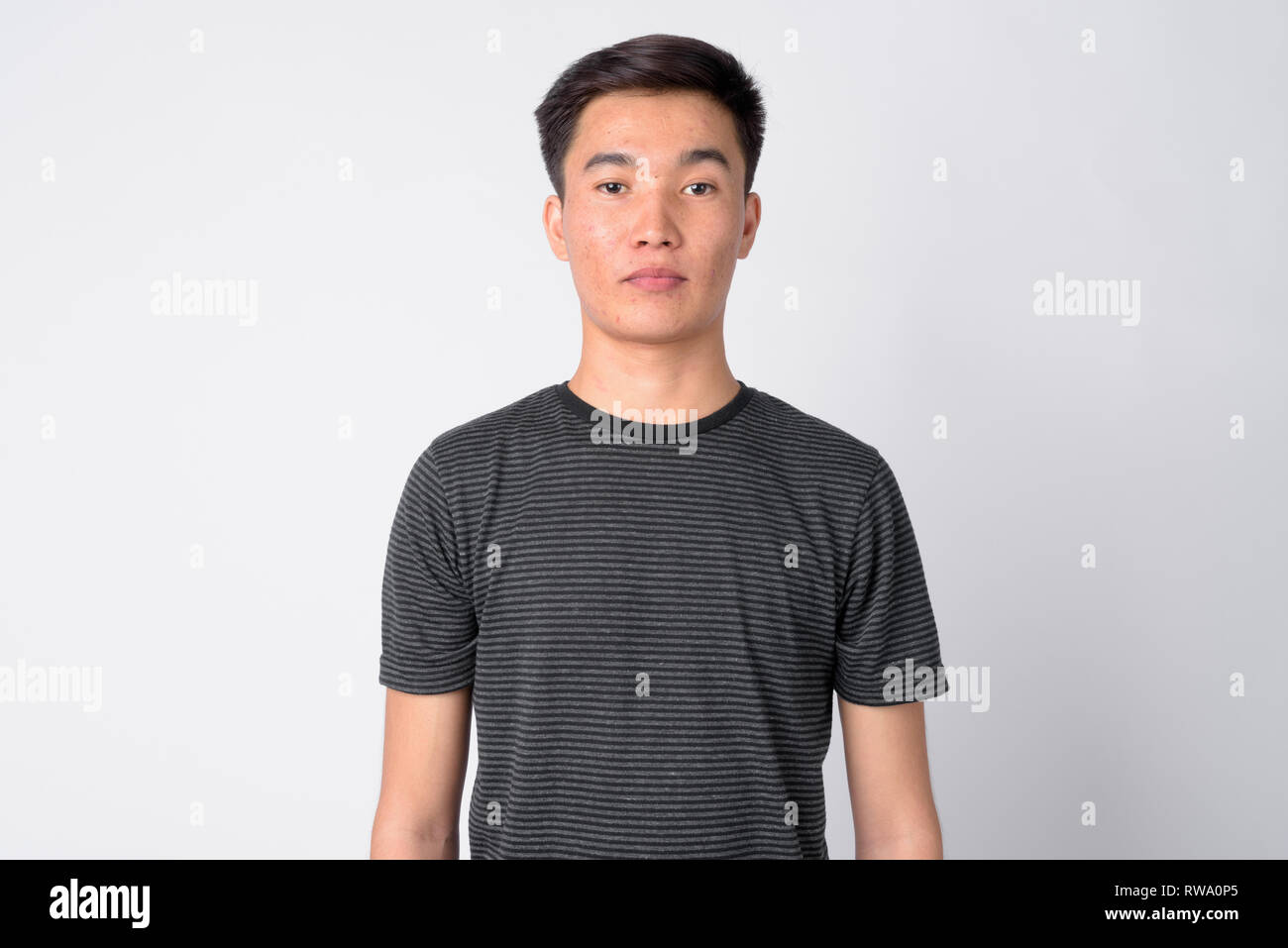 Face of young handsome Asian man against white background Stock Photo ...