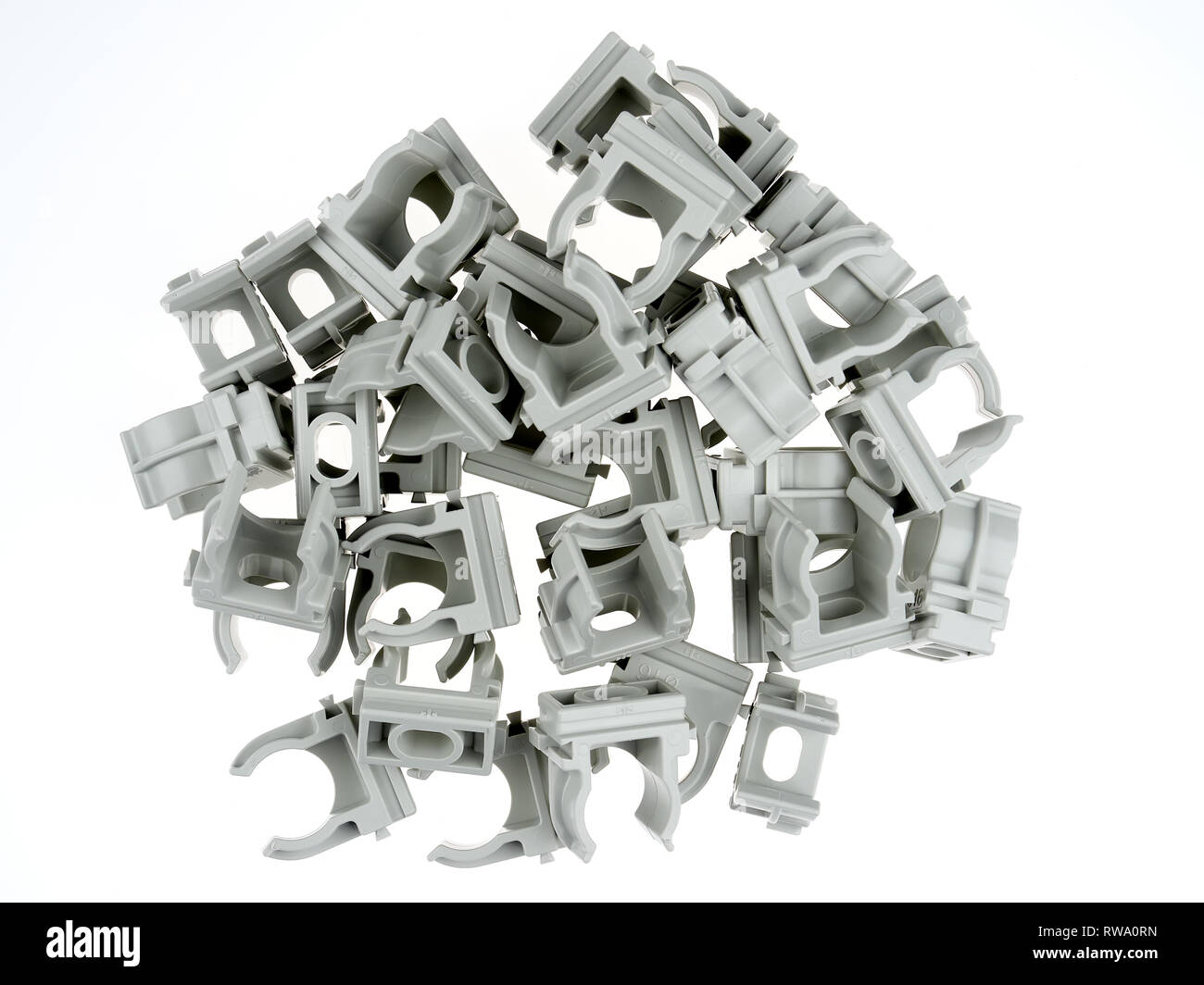 Plastic clamps for electrical tubing, isolated on white Stock Photo - Alamy