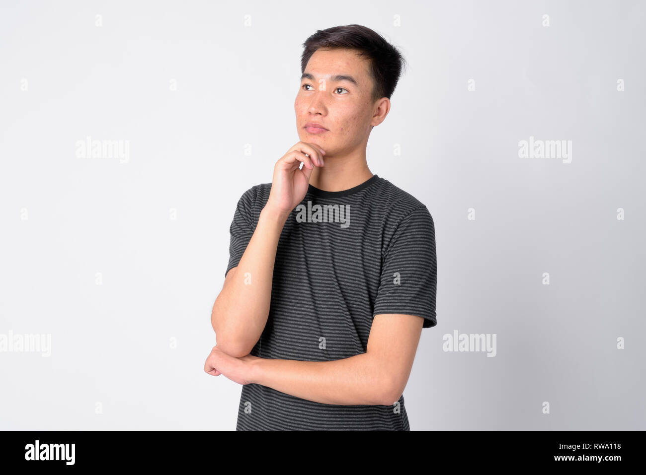 Portrait of young handsome Asian man thinking Stock Photo - Alamy