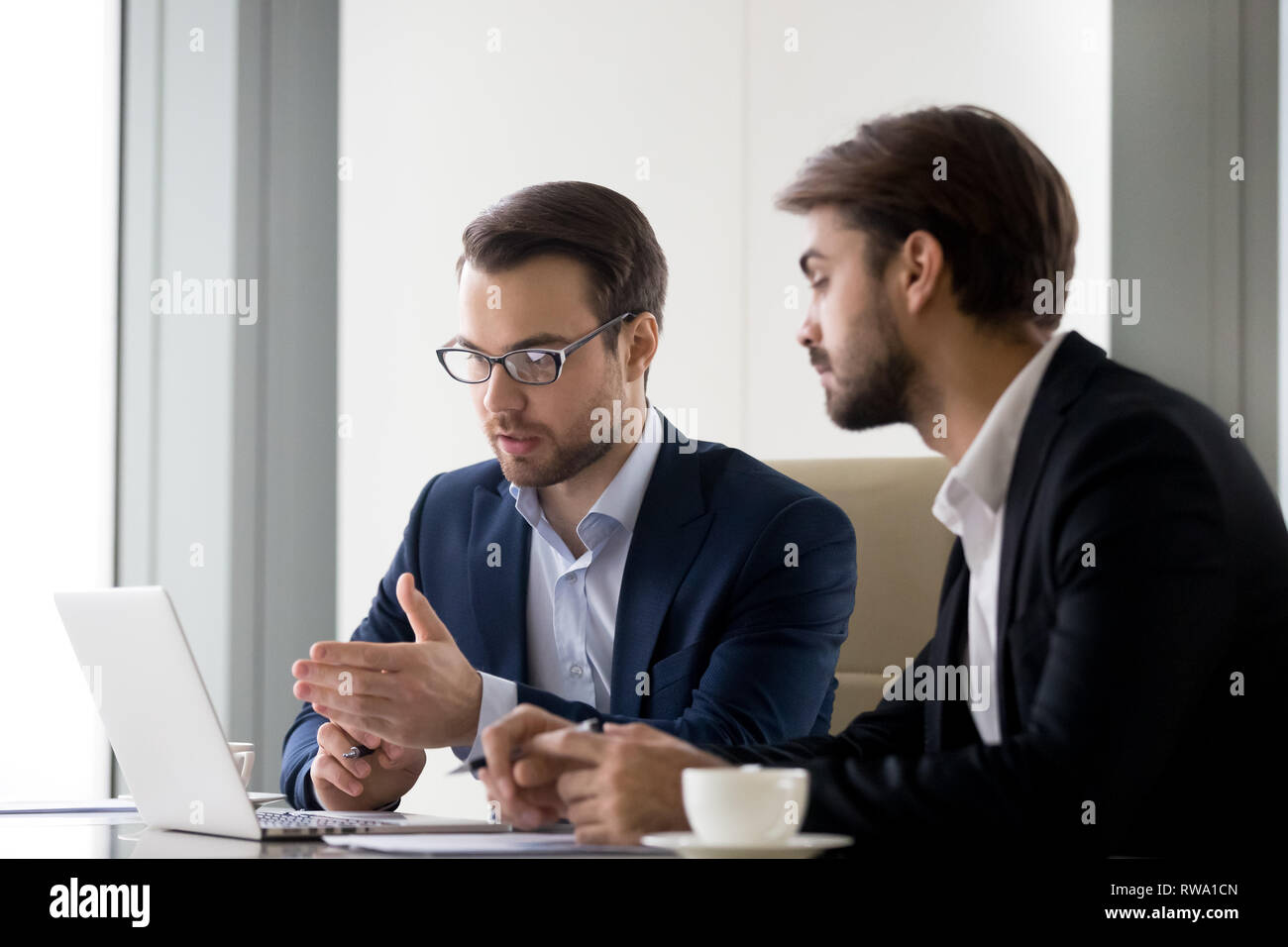 Executive businessmen colleagues working together helping in teamwork ...