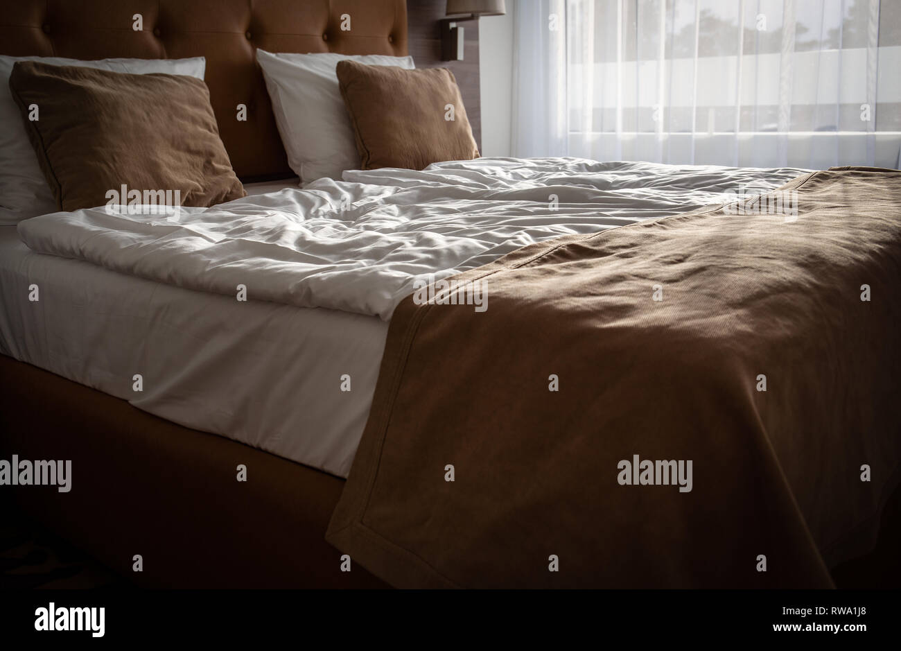Empty double bed in the room Stock Photo - Alamy