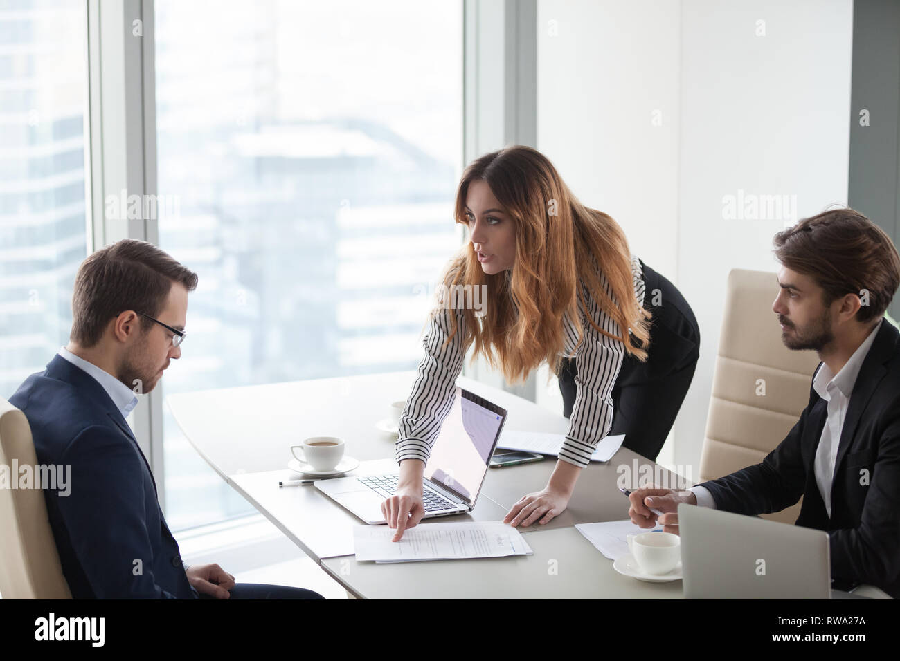 Angry female client pointing at mistake in business document Stock ...