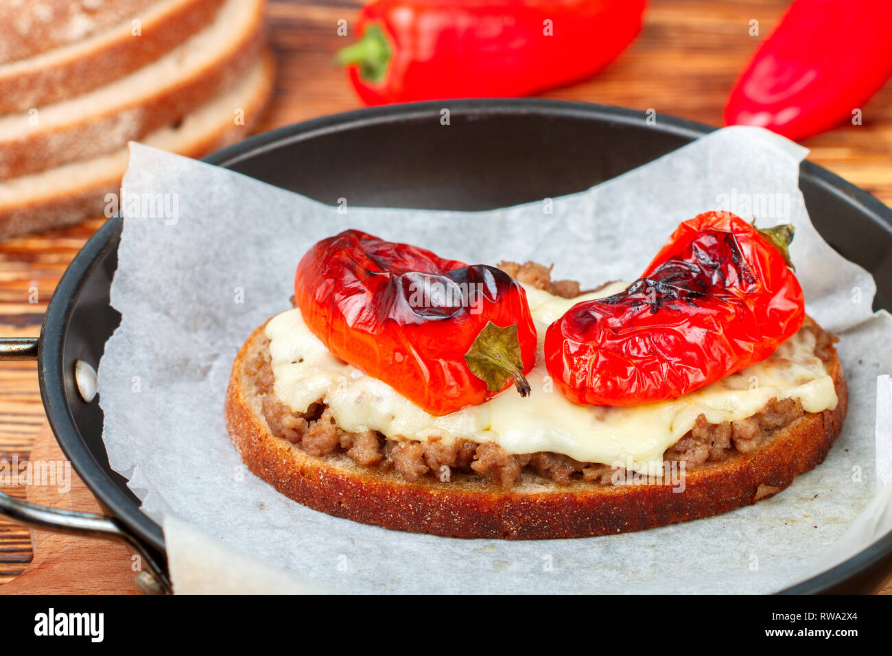 Baked bread toast with minced meat, cheese and red pepper. Delicious ...