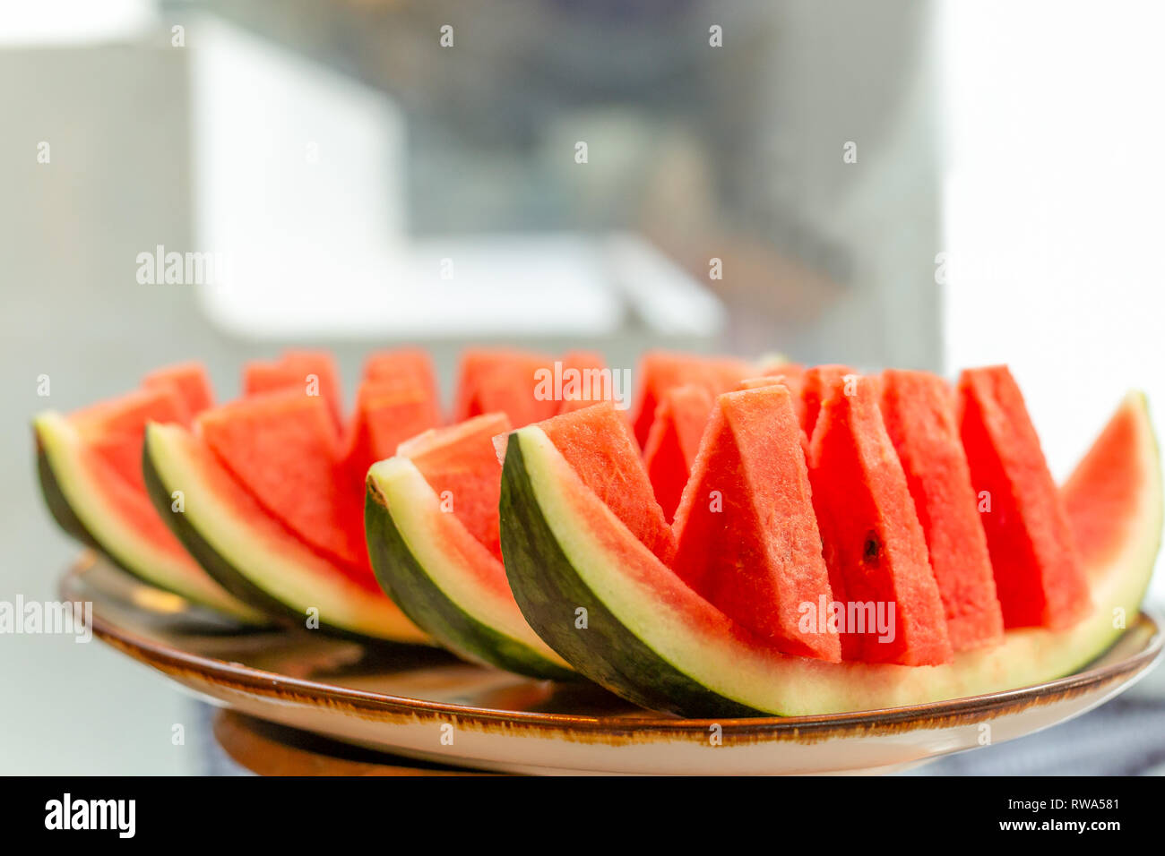 Fresh slice of watermelon on tray in blur background Stock Photo - Alamy
