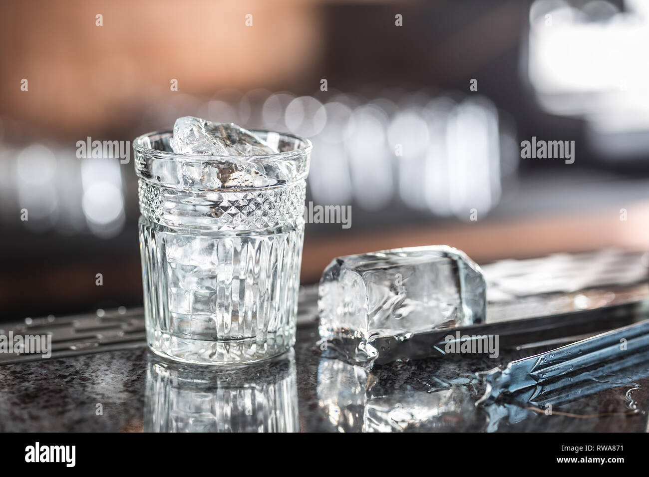 Ice cubes in glass at barcounter in night club or restaurant Stock ...