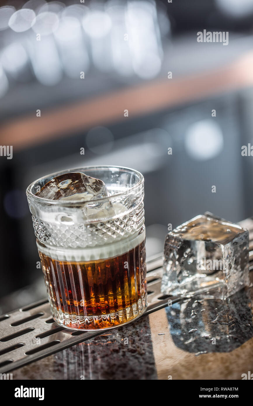 White russian cocktail drink at barcounter in night club or restaurant ...