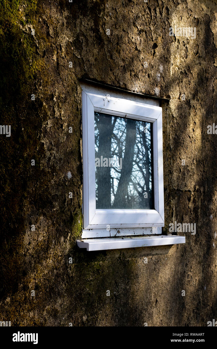 UPVC white window on derelict building awaiting demolition with ...