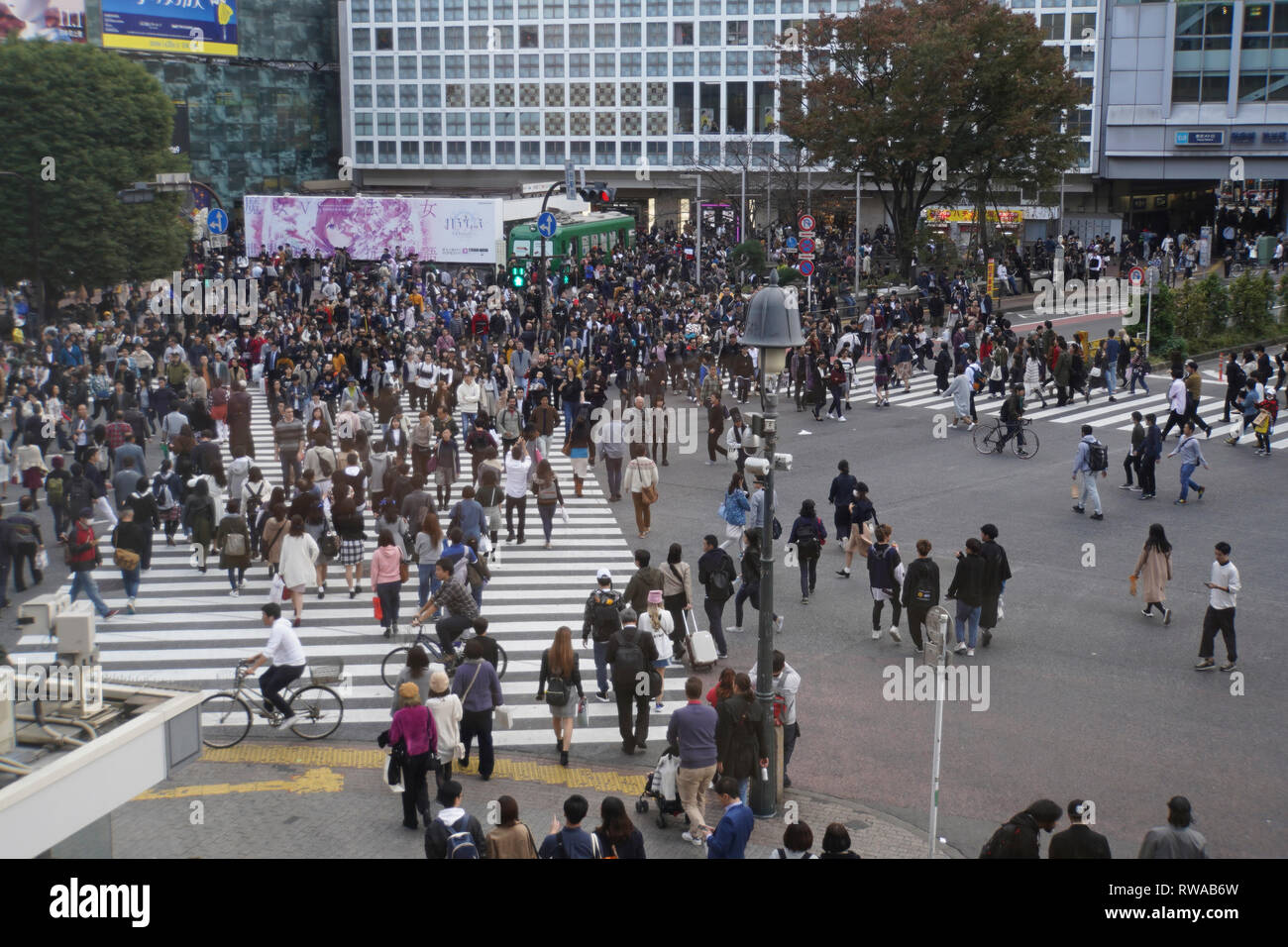 Elevated view of a crowed of pedestrians crossing a four way zebra ...