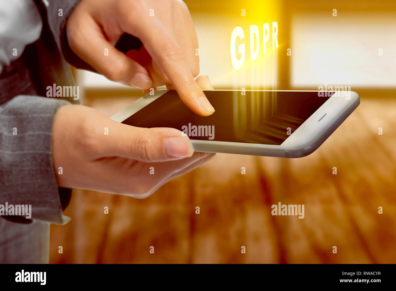 Business woman touching the mobile phone screen and display GDPR text ...