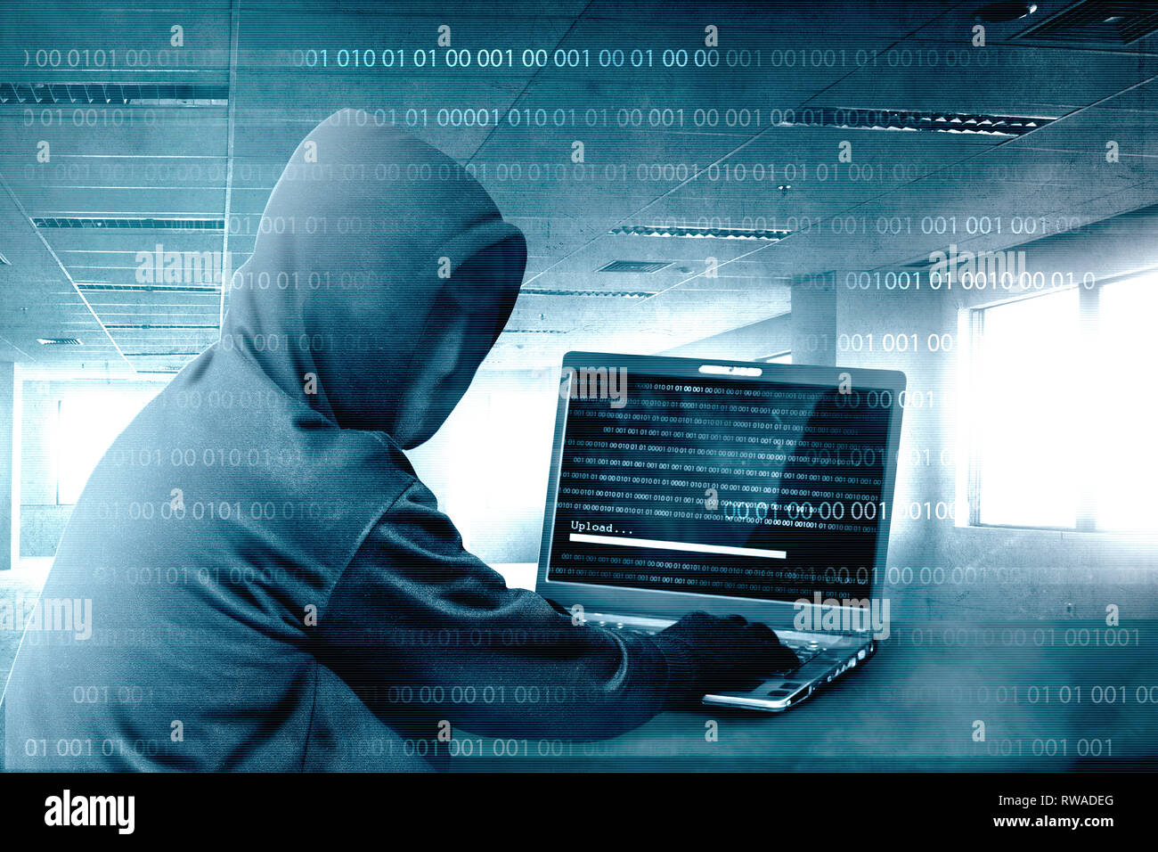 Hacker in black hoodie using laptop on the desk to hacking system with ...