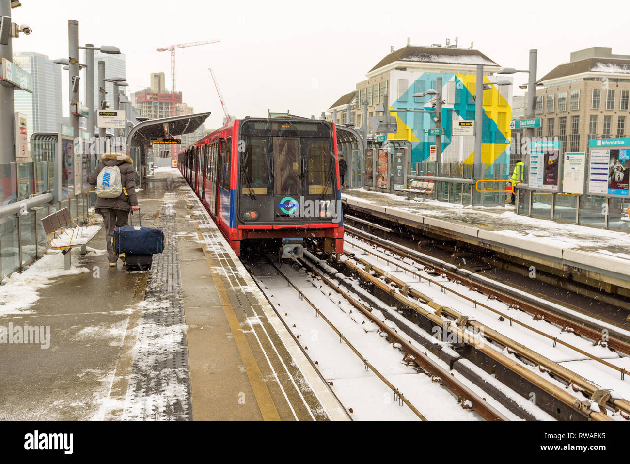 London, England - December 2017. Snow falling on a DLR train ...